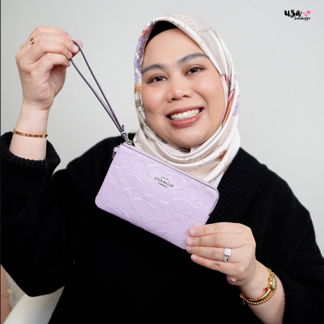 Meet the Coach Corner Zip Wristlet in Signature Leather with Heart Cha